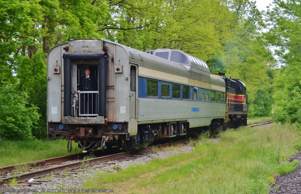 MRLX 9410 is being run out of town on a rail.